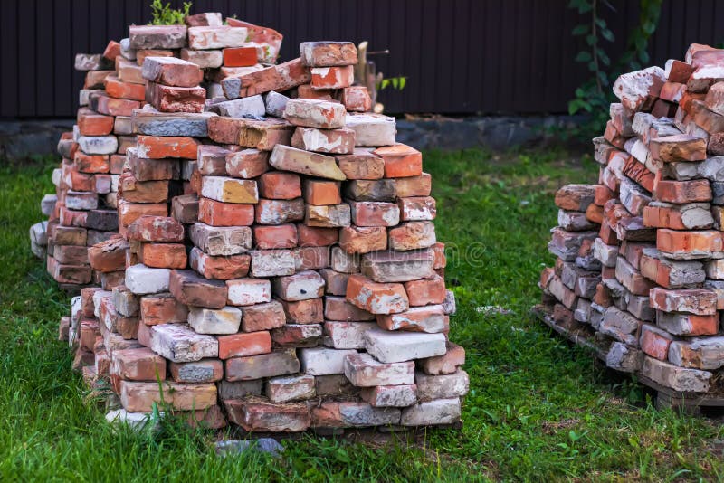 A Stack of Red Clay Bricks on a Grass Stock Image - Image of pile ...