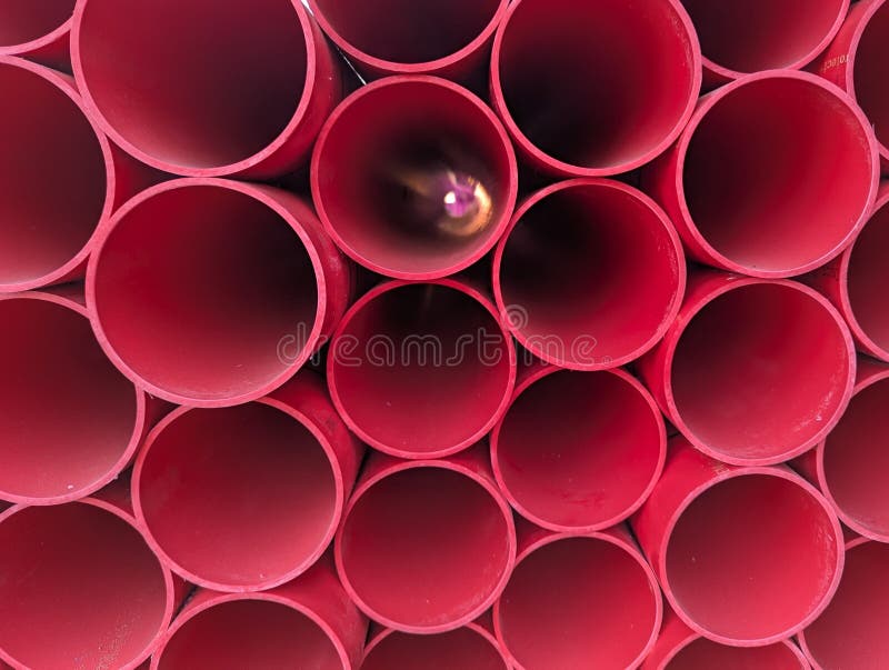 A Stack of Red Plastic Pipes Ready To Be Laid in Trenches Stock Photo ...