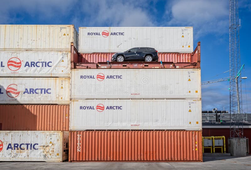 Stack of Red and White Containers with Black Car on Open Container on ...