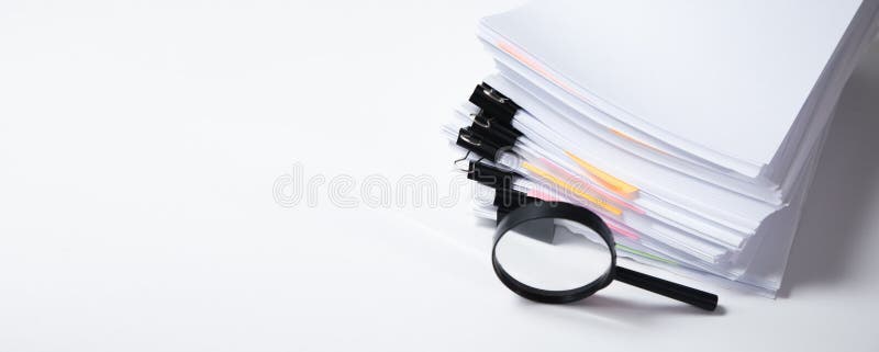 Stack of Report Paper Documents with Magnifying Glass Stock Photo ...