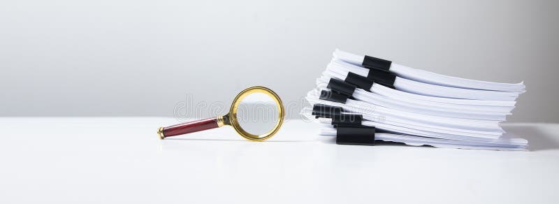Stack of Report Paper Documents with Magnifying Glass Stock Photo ...