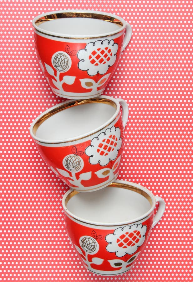 Stack Of Retro Cups With Red Patterns On A Tablecloth Whith Polka Dots ...