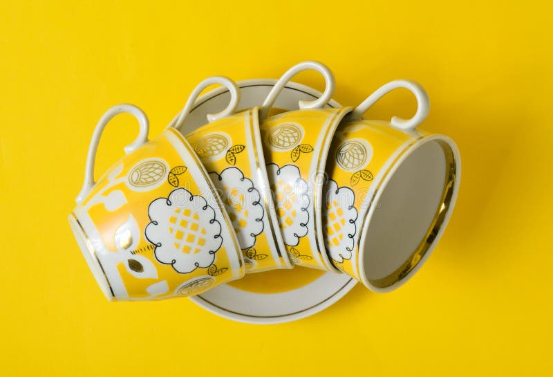 Stack of Retro Cups on a Yellow Background. Stock Image - Image of gold ...
