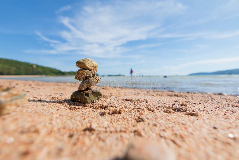 Stack of Rock Against Scenic of Summer Sand Beach and Cloudy Blu Stock ...