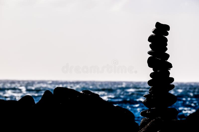 A Stack of Rocks is on a Beach Next To the Ocean Stock Image - Image of ...