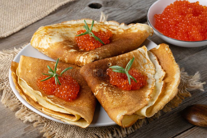 Stack of Russian Thin Pancakes Blini with Red Caviar on an Old Wooden ...
