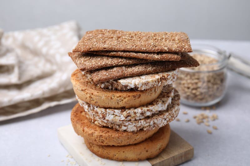 Stack of Rye Crispbreads, Rice Cakes and Rusks on White Table Stock ...