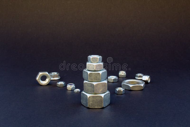 Stack of Nuts on a Gray Background Stock Image - Image of silver, bolt ...