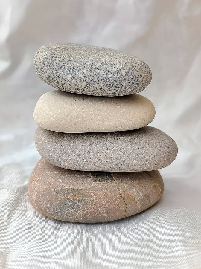 A Stack of Seven Stones Rests on a Pebbled Surface. Stock Image - Image ...