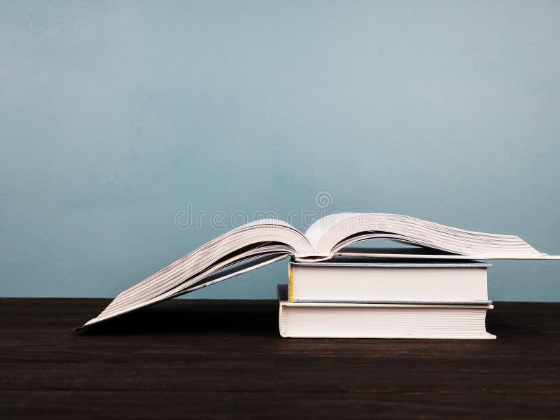 A Stack of Several Books, Close-up, Open Book in the Foreground Stock ...