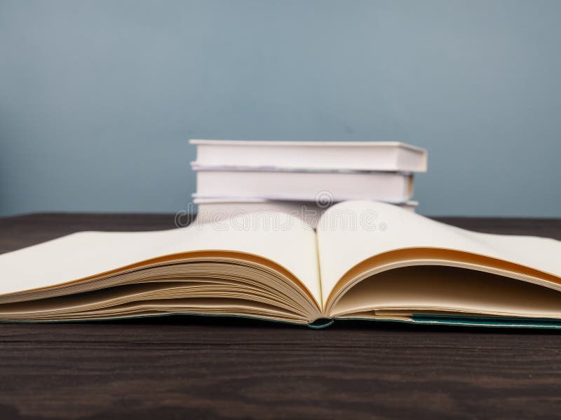 A Stack of Several Books, Close-up, Open Book in the Foreground Stock ...