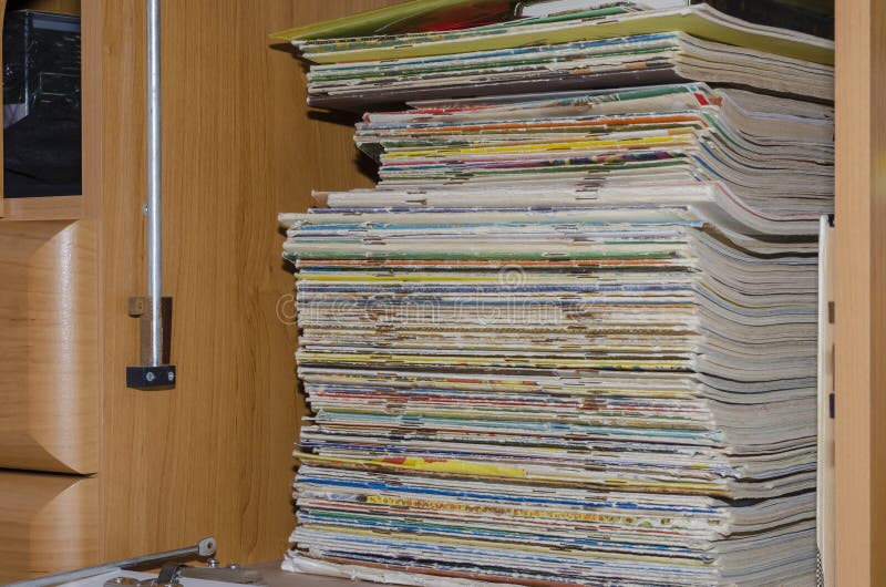 A Stack of Shabby Old Magazines and Comics on a Cabinet Shelf Stock ...