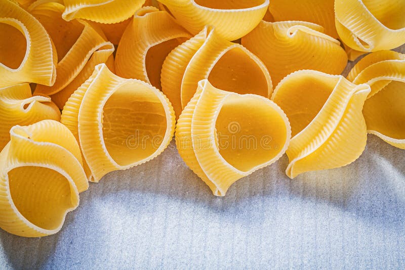 Stack of Shell Macaroni on Blue Background Food and Drink Concep Stock ...