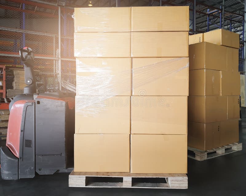 Stack of Shipment Cardboard Boxes with Electric Forklift Pallet Jack at ...