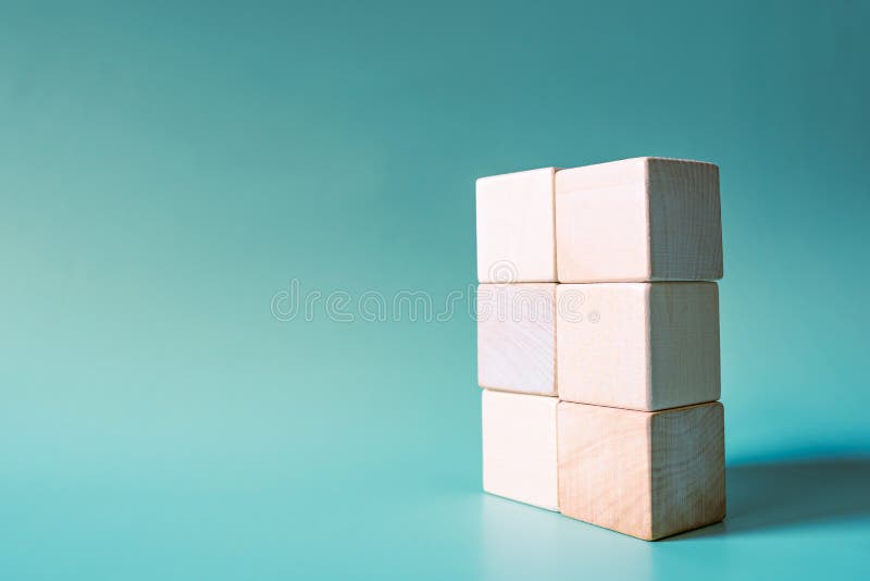 A Stack of Six Wooden Cubes on a Light Blue Background Stock Photo ...