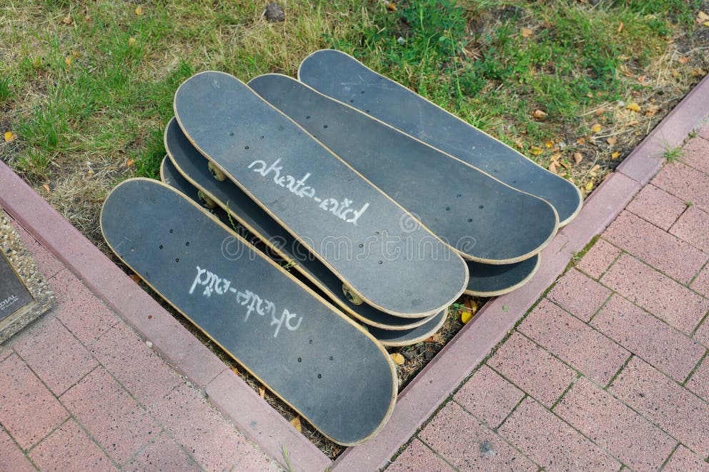 Stack of Skateboards on Sidewalk Next To Grass Edge. May 31, 2024 Balti ...