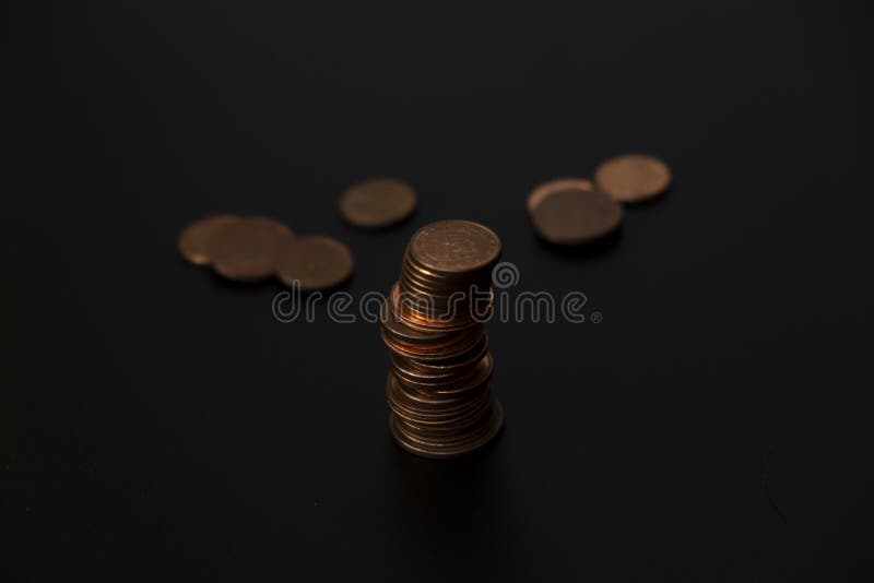 Stack of Small Coins on a Black Background Stock Image - Image of black ...
