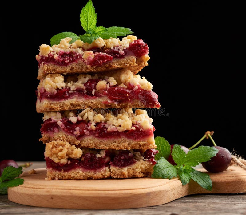 Stack of Square Slices of a Pie with Red Cherry, Black Background Stock ...