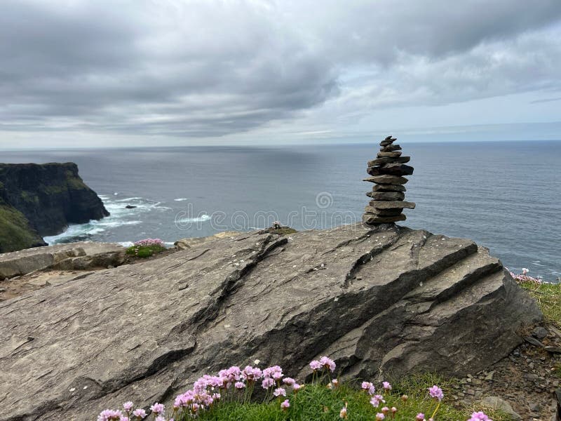 Stack of Stones Balanced on a Rocky Hillside Overlooking the Sea on the ...