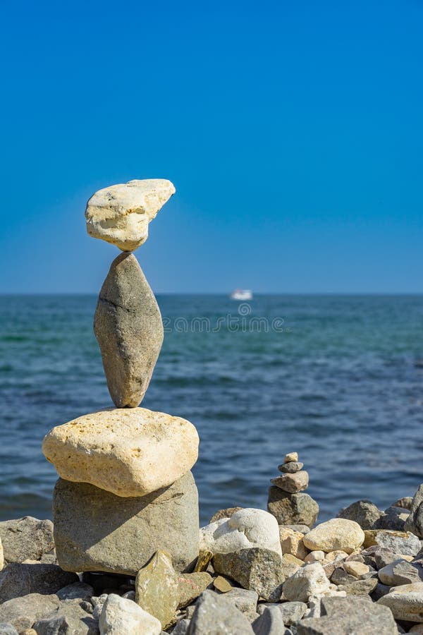 Stack of Stones Balances Precariously on the Shore. Tall and Delicate ...