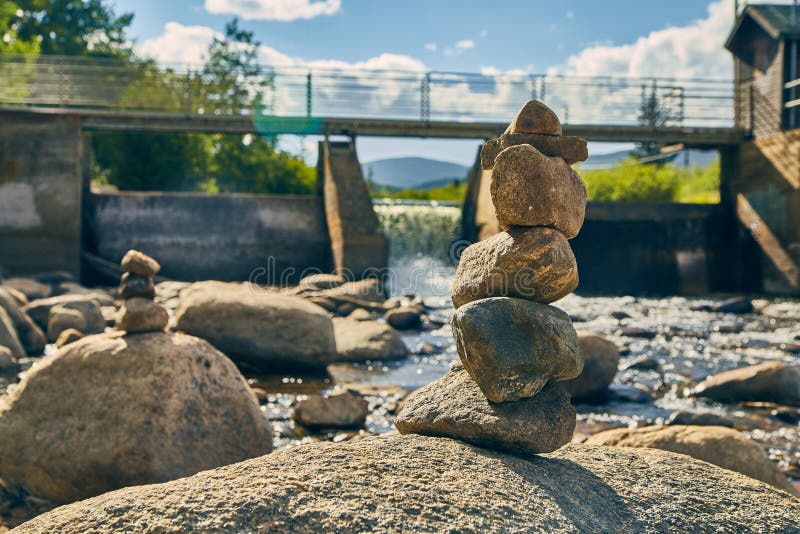 Stack of Stones Cairn Next To Dam River with Walkway Stock Image ...