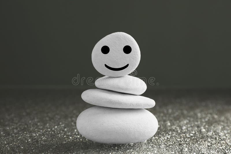 Stack of Stones with Drawn Happy Face on Grey Background. Zen Concept ...