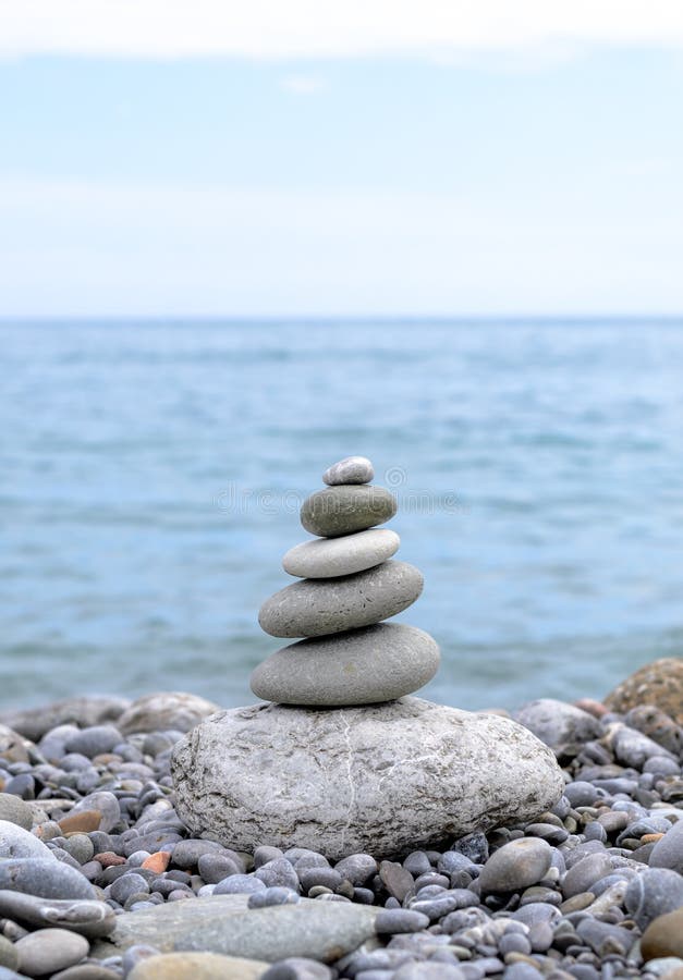 Stack of Stones Near the Beautiful Blue Ocean Stock Image - Image of ...