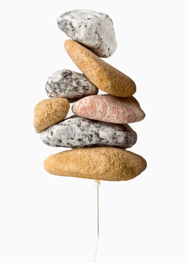 A Stack of Stones Over a Pin Stock Photo - Image of stacked, concept ...