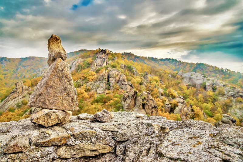 Stack of Stones with a Rocky Mountain in the Background Stock Photo ...
