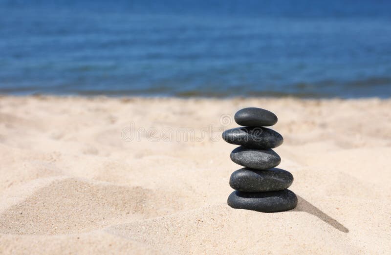 Stack of Stones on Sand Near Sea. Zen Concept Stock Photo - Image of ...