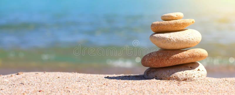 Stack of stones on sand stock photo. Image of stones - 248339586