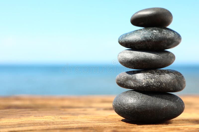 Stack of Stones on Wooden Table Against Seascape. Zen Concept Stock ...