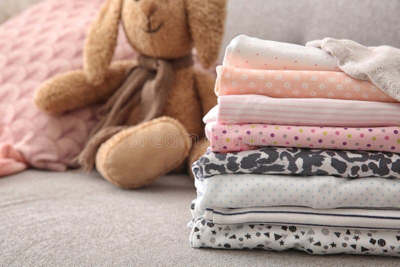 Stack of Stylish Child Clothes Stock Photo - Image of fashion, couch ...