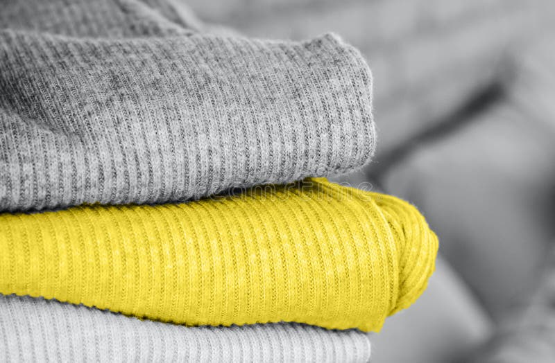 A Stack of Sweaters in Trendy Colors Yellow and Gray Stock Image ...