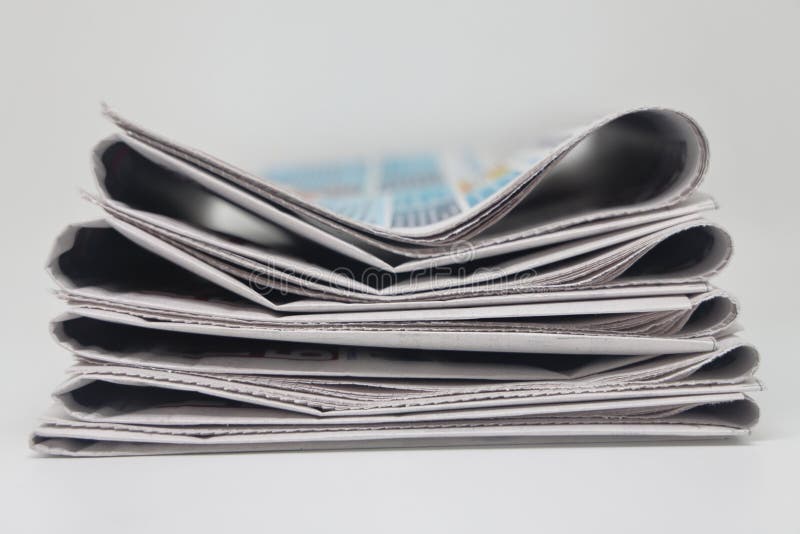 A Stack of Tabloid Format Folded Newspapers Isolated on White ...