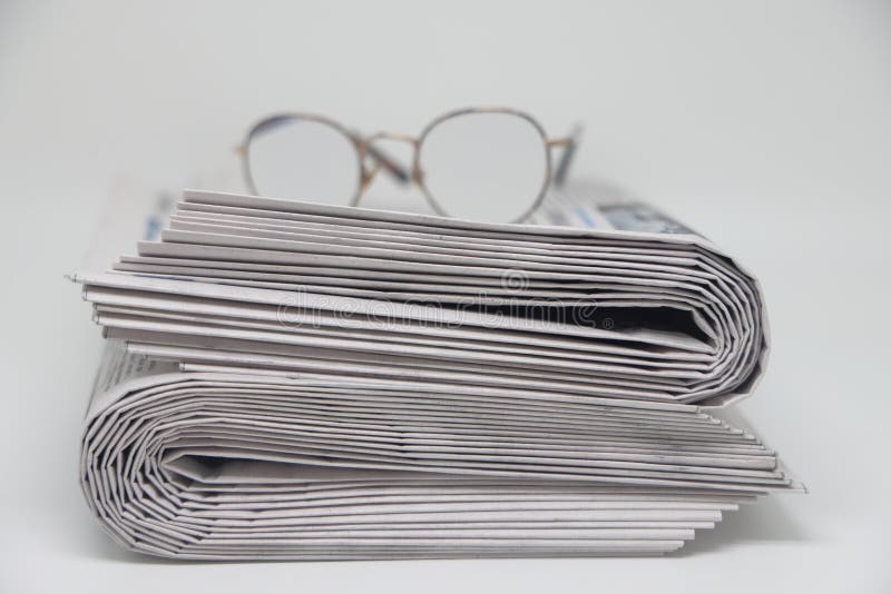A Stack of Tabloid Format Folded Newspapers Isolated on White ...