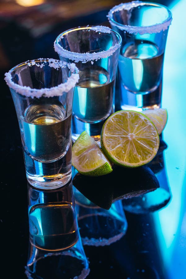 Stack of Tequila with Salt Close Up on Blurred Background Stock Photo ...