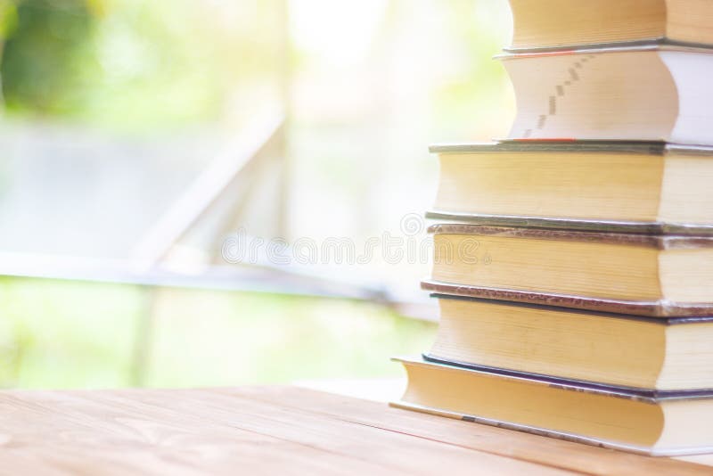 Stack of Thick Books with Beautiful Light and Bokeh Background Stock ...