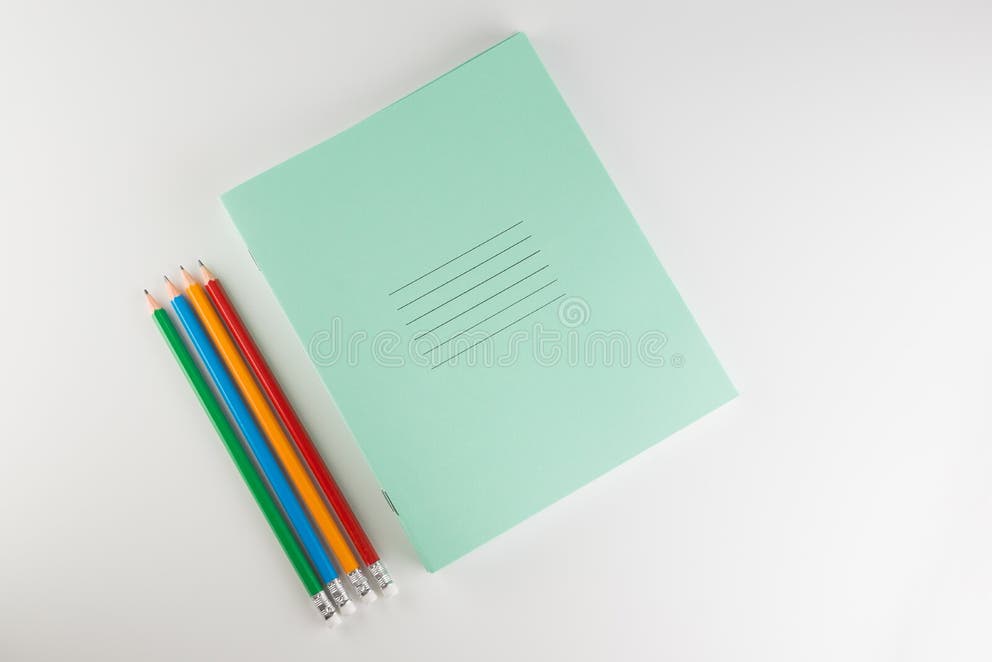 Stack of Thin Student Notebooks with Colored Pencils Stock Photo ...