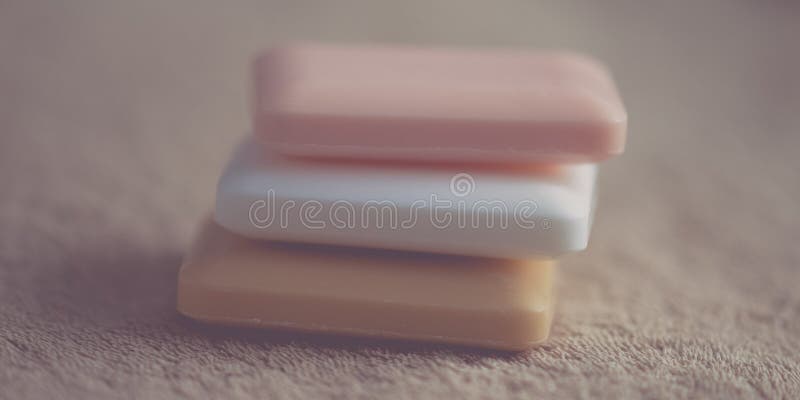 Stack of Three Bars of Soap Different Colors on a Brown Towel. Stock ...