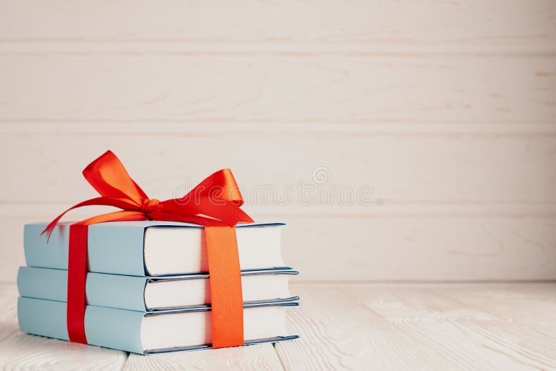 A Stack of Three Books Tied with a Red Ribbon with a Bow and Copy Space ...