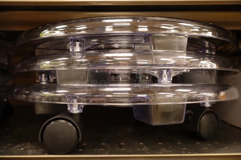 Stack of Three Clear Plastic Rolling Plant Base Stock Photo - Image of ...