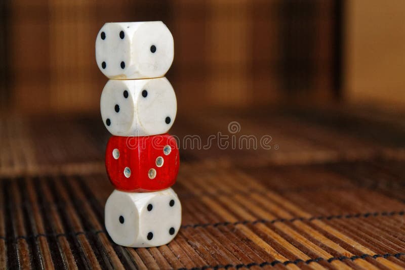 Stack of Three White Plastic Dices and One Red Dice on Brown Wooden ...