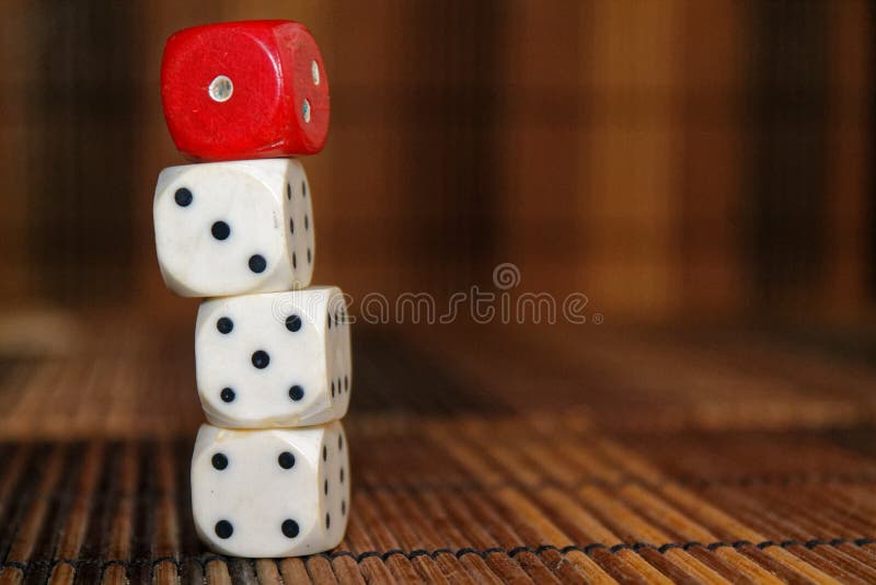 Stack of Three White Plastic Dices and One Red Dice on Brown Wooden ...