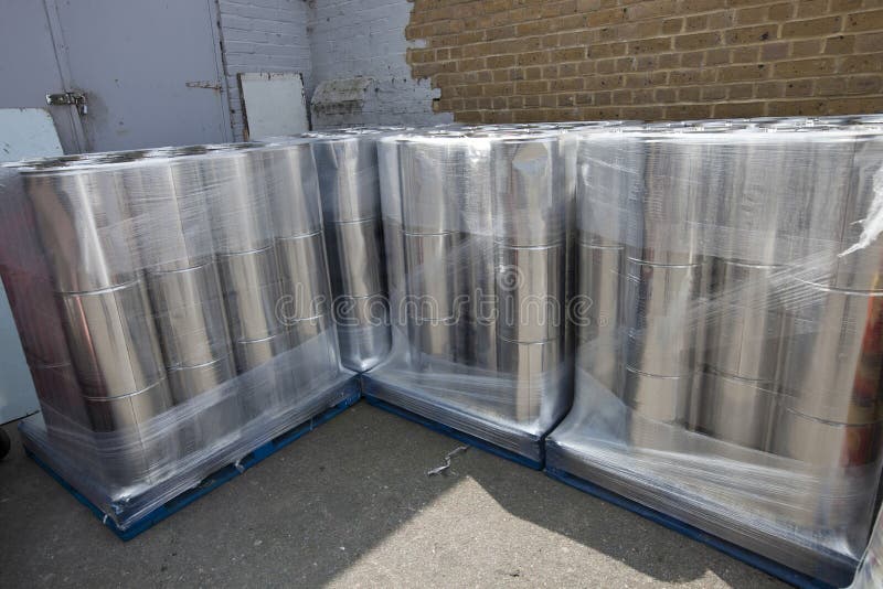 Stack of Tins Outside Warehouse Stock Photo - Image of wrapped ...
