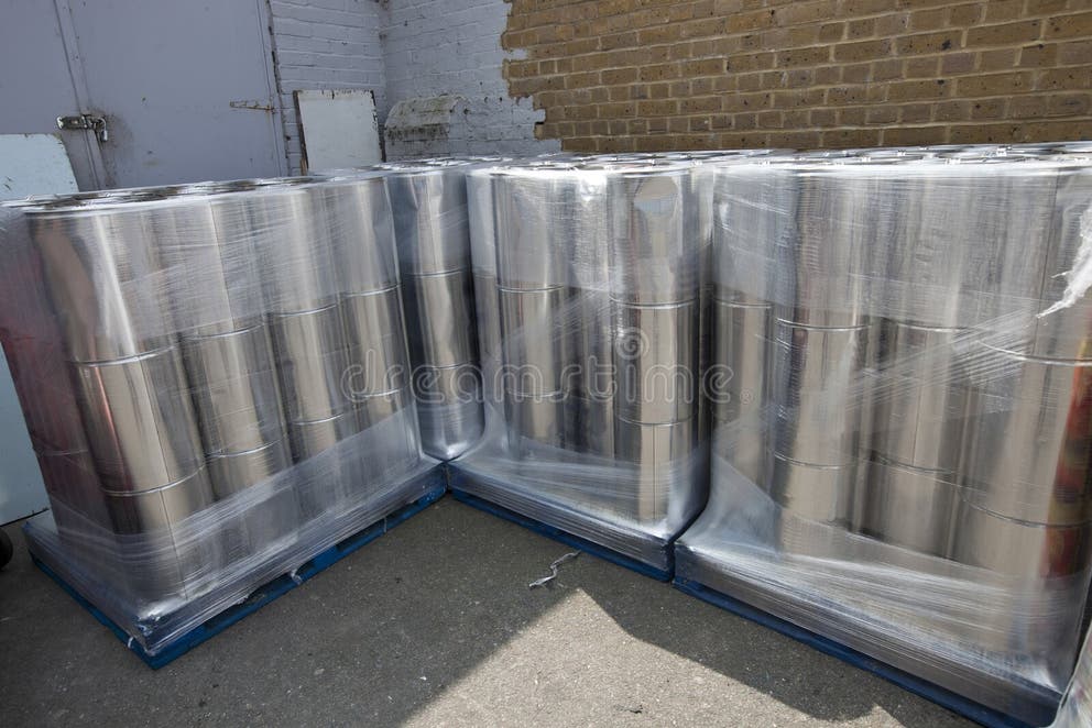 Stack of Tins Outside Warehouse Stock Photo - Image of wrapped ...
