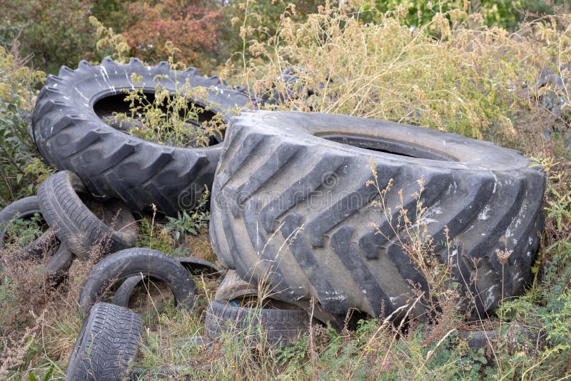 A Stack of Tires on an Old Garbage Dump. Old Worn Out Tires Pile Stock ...