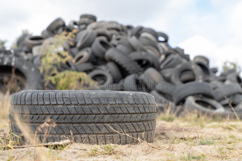 A Stack of Tires on an Old Garbage Dump. Old Worn Out Tires Pile Stock ...