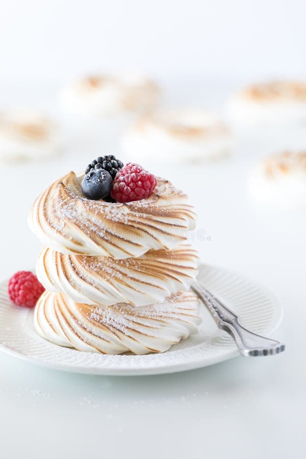 A Stack of Toasted Meringues and Berries Against a White Background ...