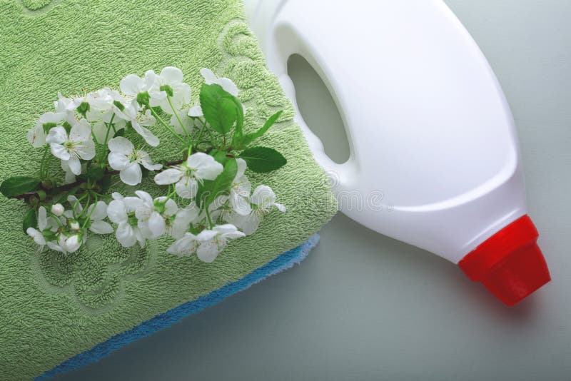 Towels with Flowers and Bottle for Liquid Laundry Stock Image - Image ...